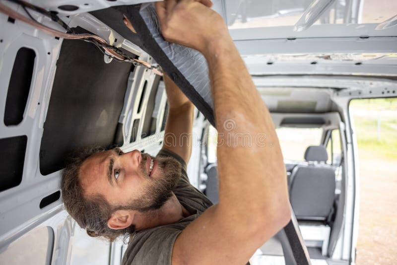 Man Attaches Thermal Insulation On The Inside Of A Van Stock Image ...