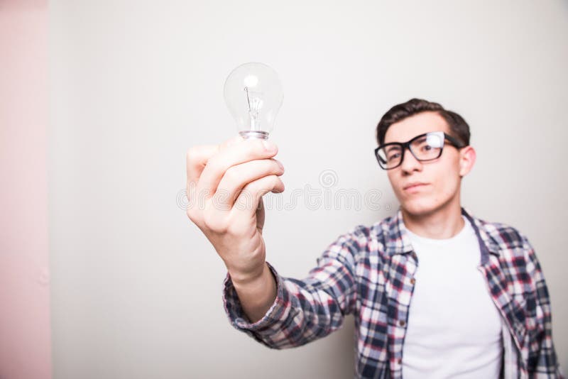 Young Man Standing and Looking at Light Bulb Stock Image - Image of ...
