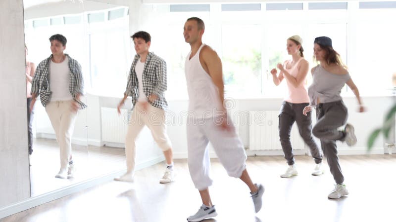 Young Man Standing Performs Basic Hip Hop Movements in Front of Group ...