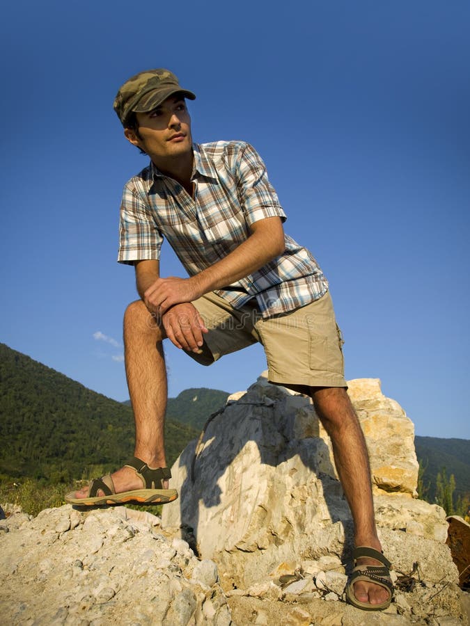 Young Man Standing on Rocks in Mountains Stock Photo - Image of ...