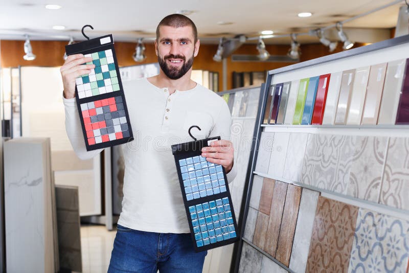 Young Man Standing with Sample of Ceramic Tile Stock Photo - Image of ...