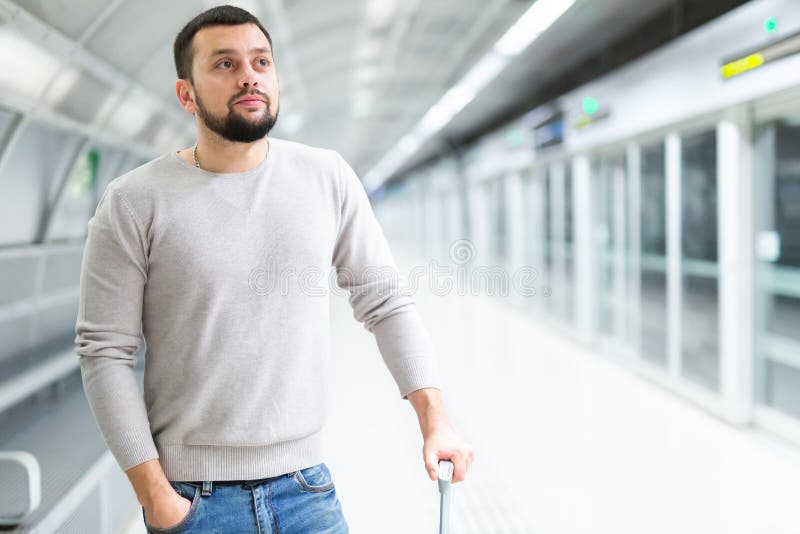 Young Man Standing with Suitcase on Subway Station Platform Stock Photo ...