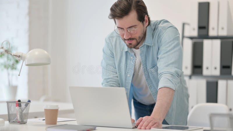 Young Man Standing and Working on Laptop Stock Image - Image of ...