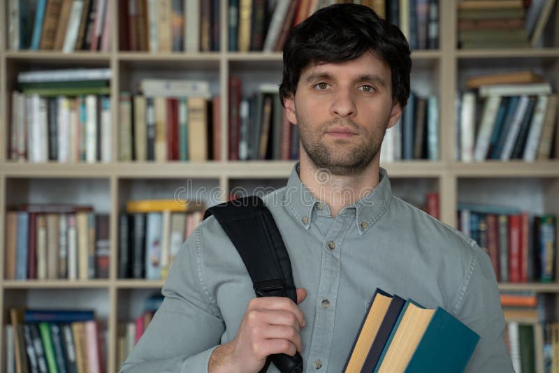 Young Man Stands with Books and a Backpack in the Library Stock Image ...