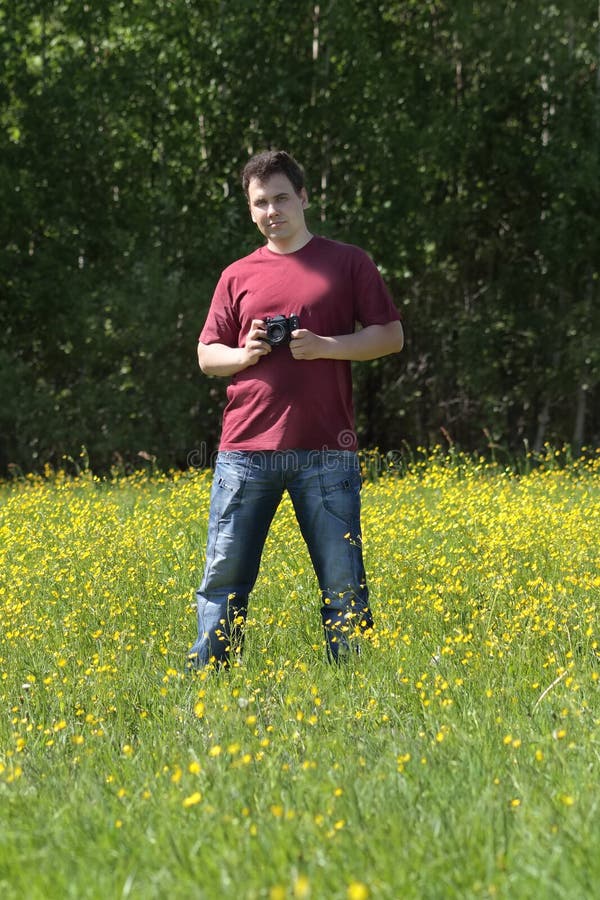 Young Man Stands with Camera among Yellow Flowers Stock Image - Image ...