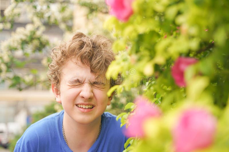 Young Man Stands among the Flowers and Enjoys Summer and Flowering ...