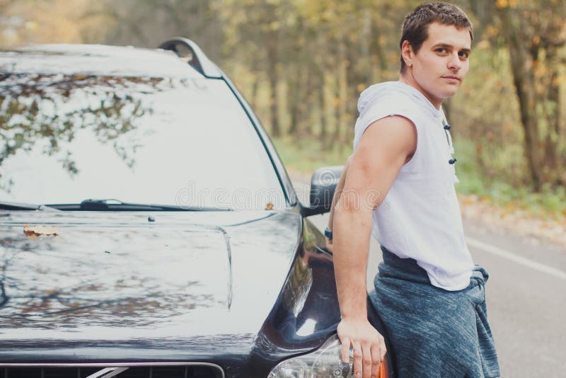 A young man near the car stock image. Image of white - 100531539