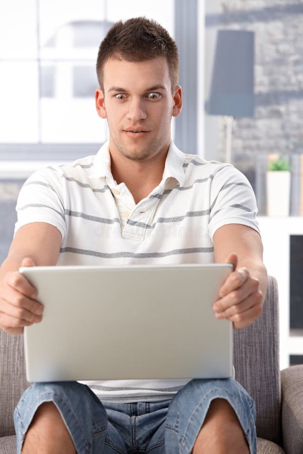 Young Man Staring at Laptop Screen Horrified Stock Photo - Image of ...