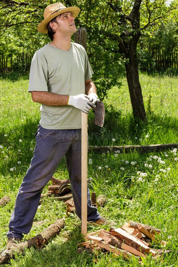 Young Man with a Straw Hat Taking a Break after Cutting Wood. Stock ...