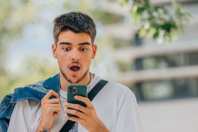 Young Man in the Street Looking at the Phone Stock Image - Image of ...