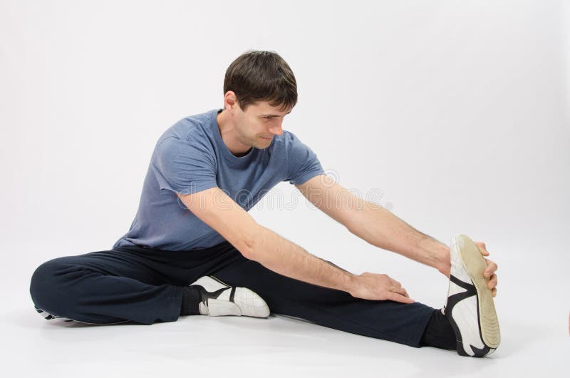 The Young Man Stretches Muscles of Left Leg Stock Photo - Image of ...