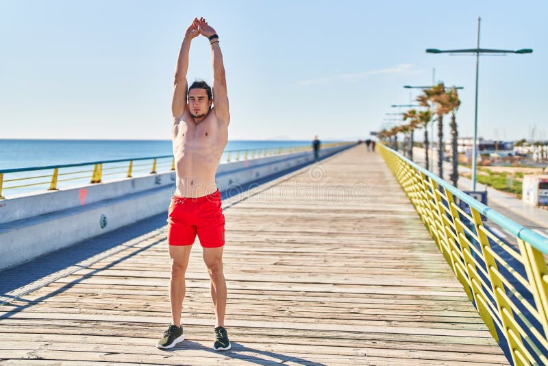 Young Man Stretching Arms at Seaside Stock Photo - Image of male ...