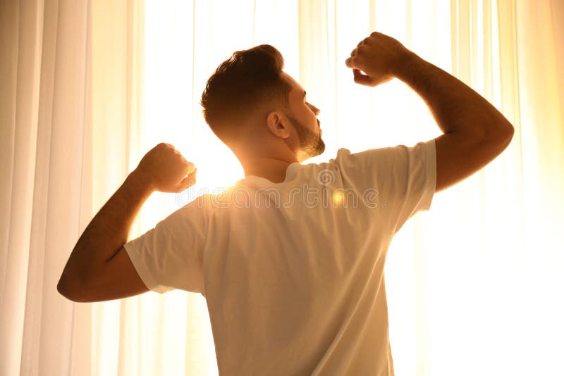 Young Man Stretching Near Window at Home Stock Image - Image of ...