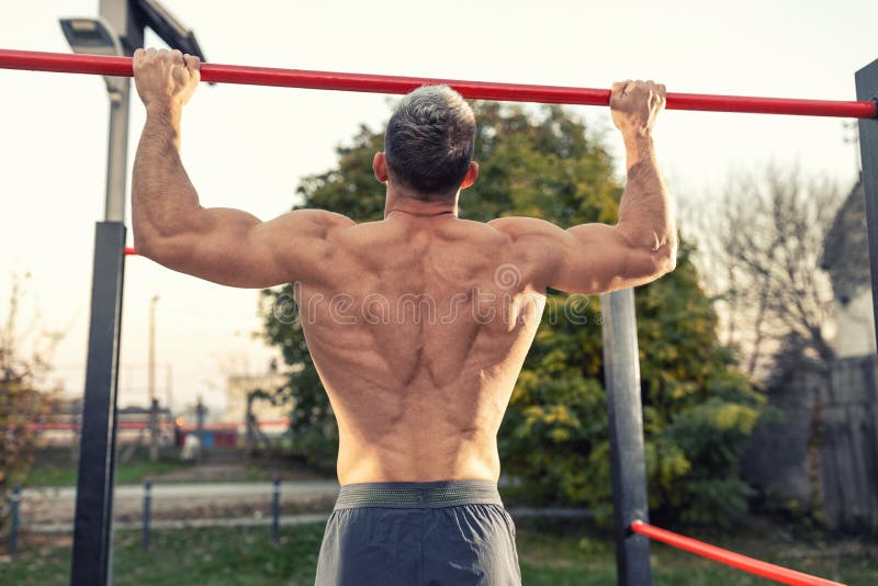 Shirtless Ripped Young Man Doing Pull Ups Outdoors and Showing ...