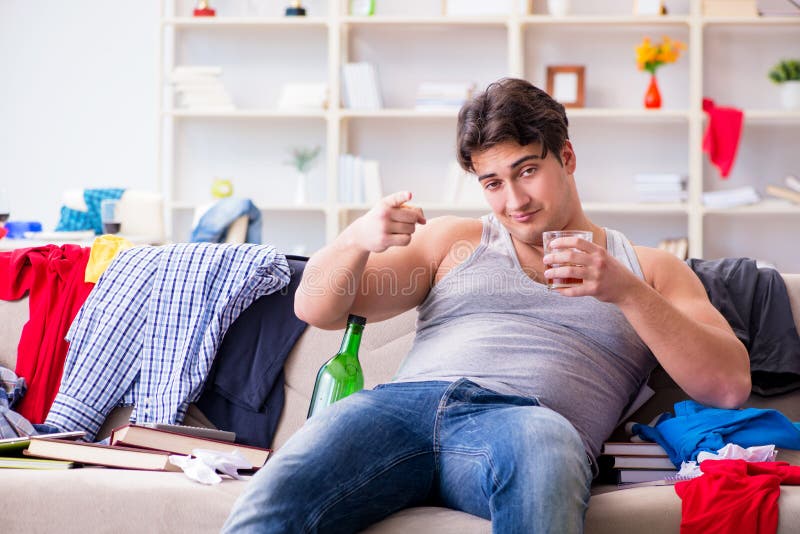 The Young Man Student Drunk Drinking Alcohol in a Messy Room Stock ...