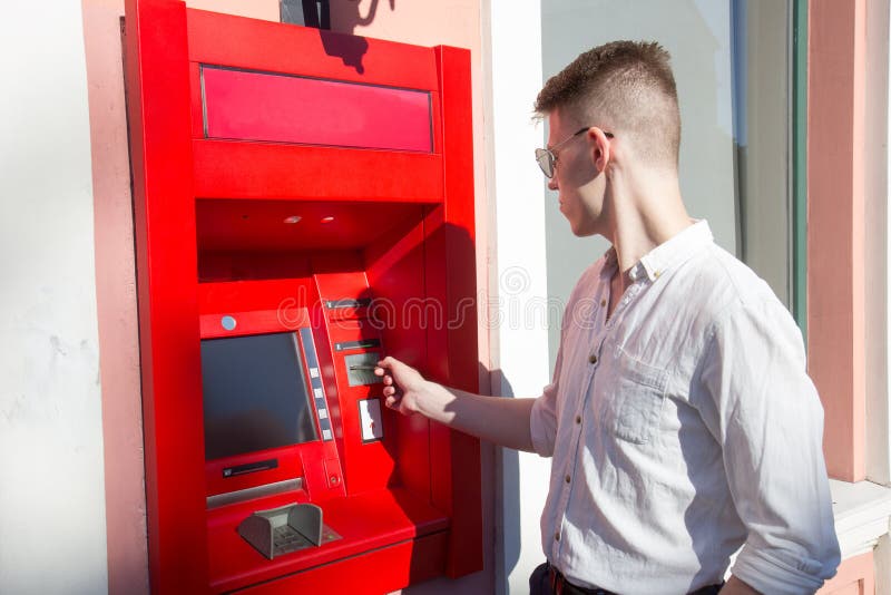 Young Man Using Cash Machine Stock Image - Image of deposit, finance ...