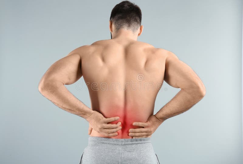 Young Man Suffering from Back Pain on Light Background Stock Image ...