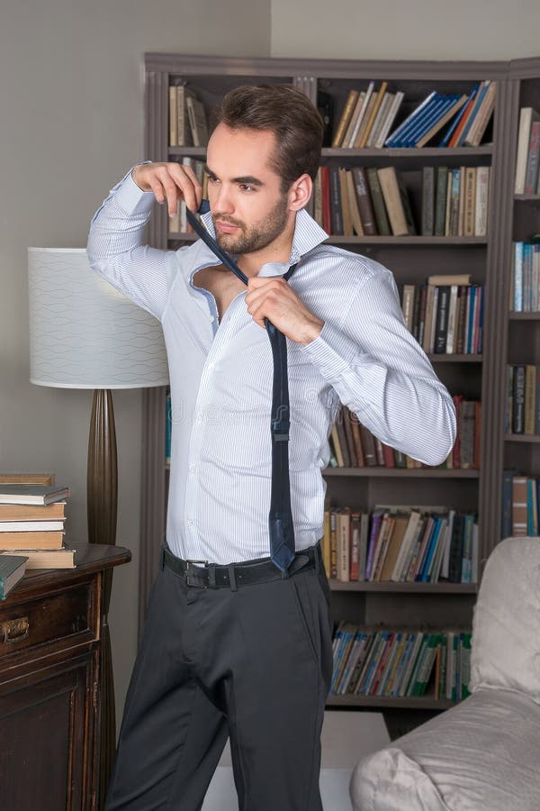 Young Man in a Suit Takes His Tie Off Stock Photo - Image of caucasian ...