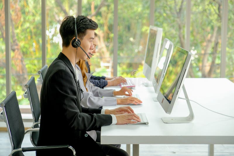 Young Man with Suit Work As Operator of the Company with Different ...
