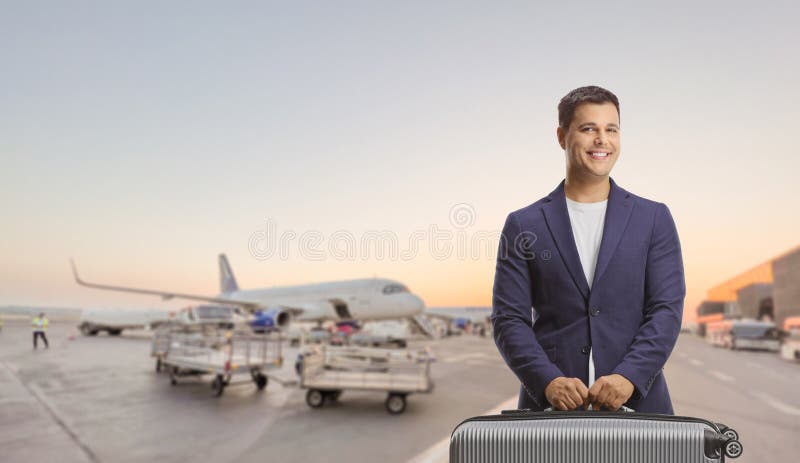 Young Man with a Suitcase Standing on an Airport Stock Image - Image of ...