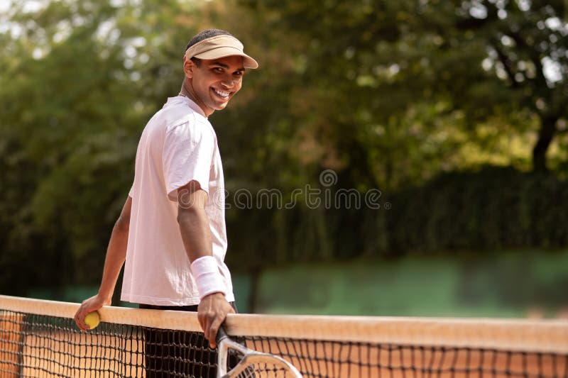 Young Man in Sun Visor at the Tennis Courts Stock Photo - Image of ...
