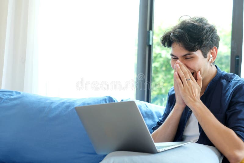 Young Man Surprising while Looking at Laptop Computer, Work at Home ...