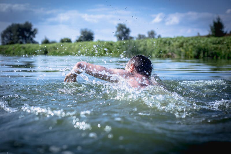 The Young Man Swimming in the River Stock Photo - Image of drops ...