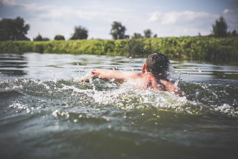 The Young Man Swimming in the River Stock Photo - Image of person ...