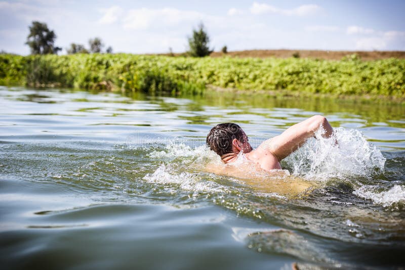 The Young Man Swimming in the River Stock Image - Image of solo ...