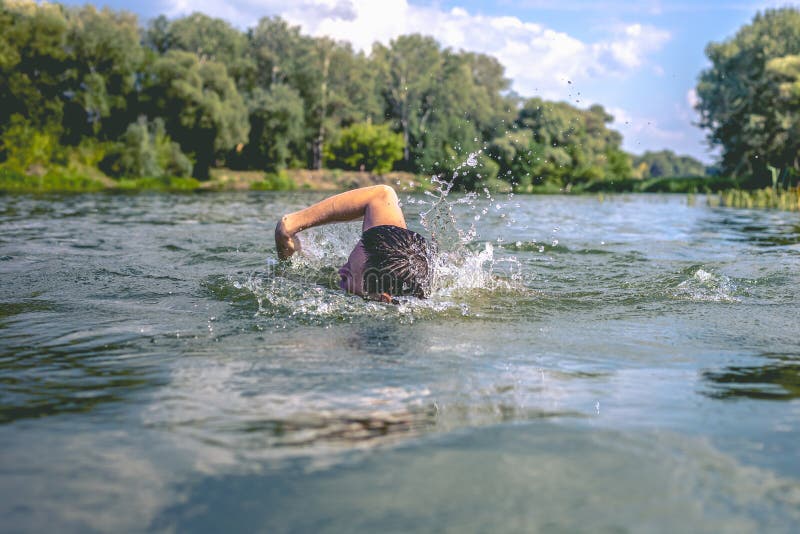 The Young Man Swimming in the River Stock Image - Image of male ...