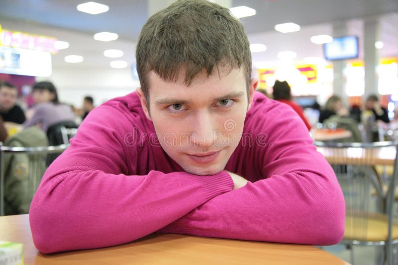 Young man at table in cafe stock image. Image of indoors - 5450561