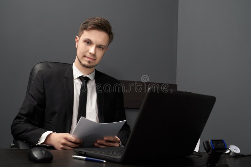 Young Man at Table with Computer Polygraph in Grey Room. Stock Photo ...