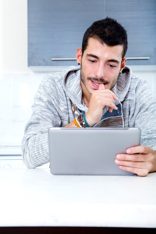 Young Man with Tablet in the Kitchen Stock Photo - Image of kitchen ...