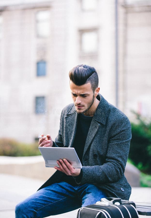 Young man with tablet stock image. Image of booking, grey - 90162687