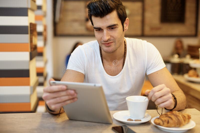 Young man with tablet stock photo. Image of food, handsome - 84571404