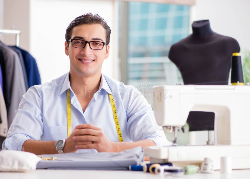 Young Man Tailor Working on New Clothing Stock Photo - Image of ...