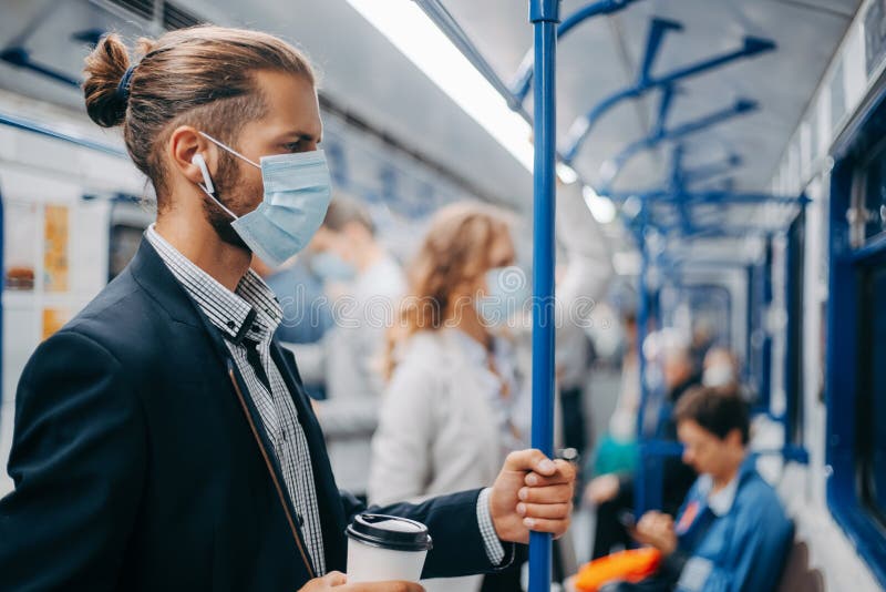 Young Man with a Takeaway Coffee Standing in a Subway Car. Stock Image ...