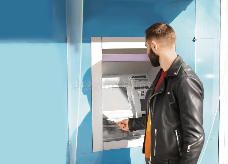 Young Man Taking Money from Cash Machine Stock Photo - Image of ...