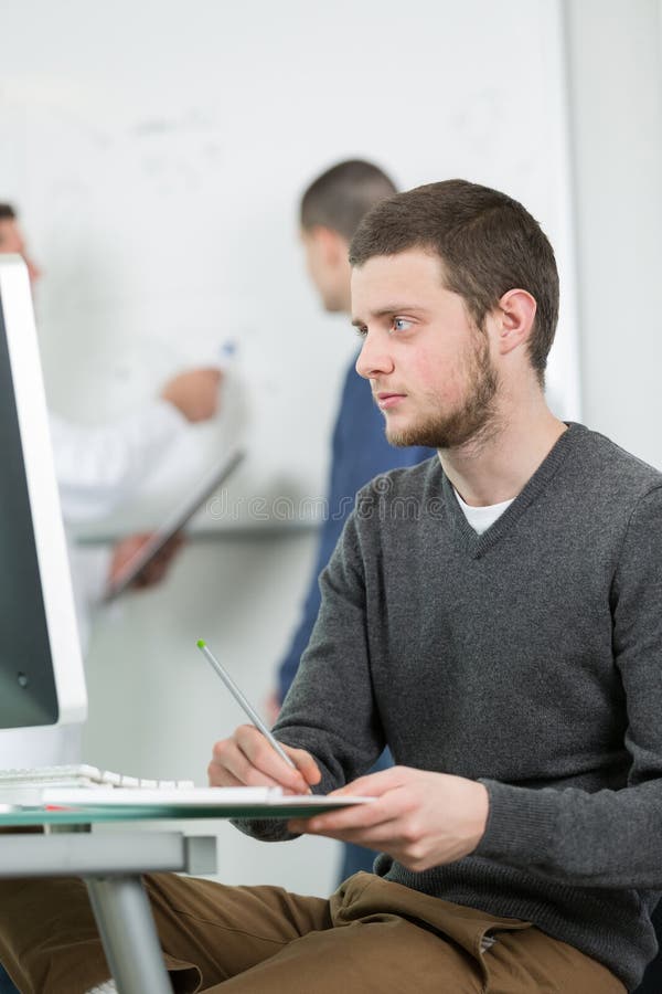 Young Man Taking Notes Form Computer Stock Image - Image of people ...