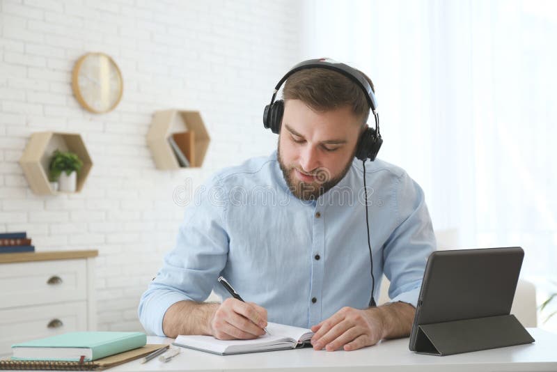 Young Man Taking Notes during Online Webinar at Table Indoors Stock ...