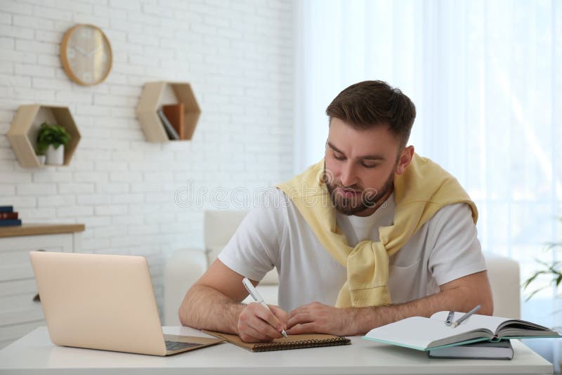 Young Man Taking Notes during Webinar at Table Indoors Stock Image ...