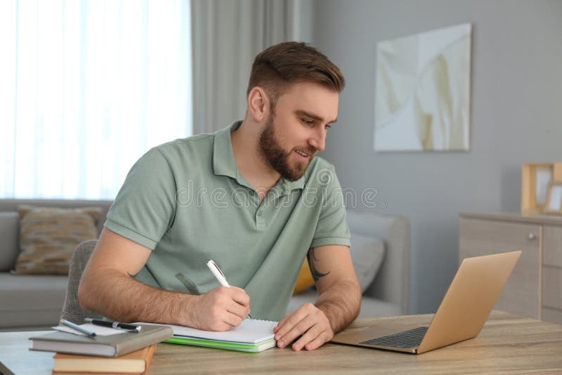 Young Man Taking Notes during Online Webinar at Table Indoors Stock ...