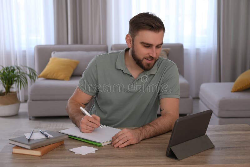 Young Man Taking Notes during Online Webinar at Table Indoors Stock ...