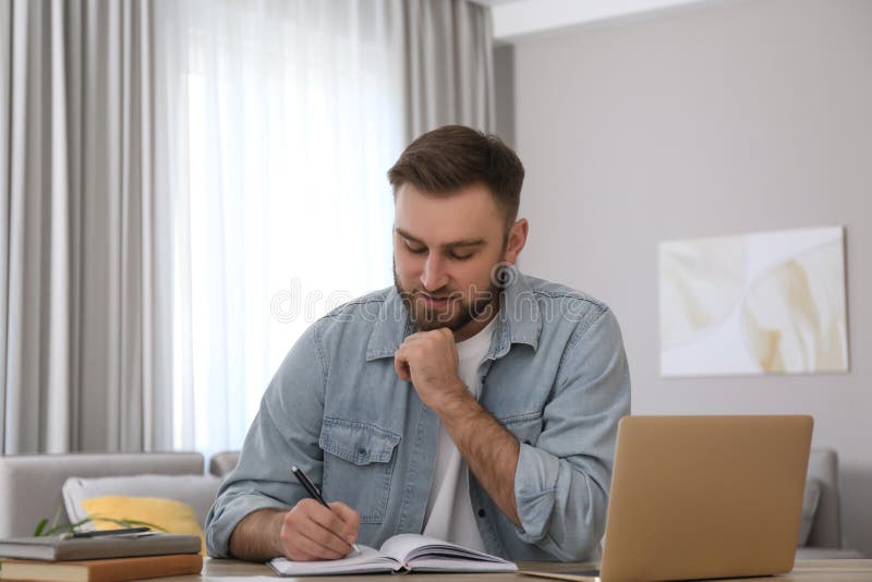 Young Man Taking Notes during Online Webinar at Table Indoors Stock ...