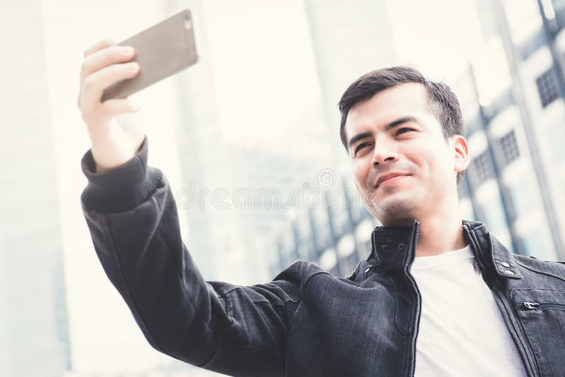 Young Man Taking Selfie with Smartphone Stock Photo - Image of black ...