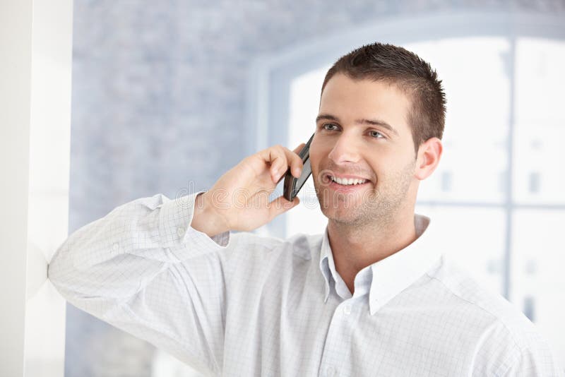 Young Man Talking on Mobile Phone Smiling Stock Image - Image of chat ...