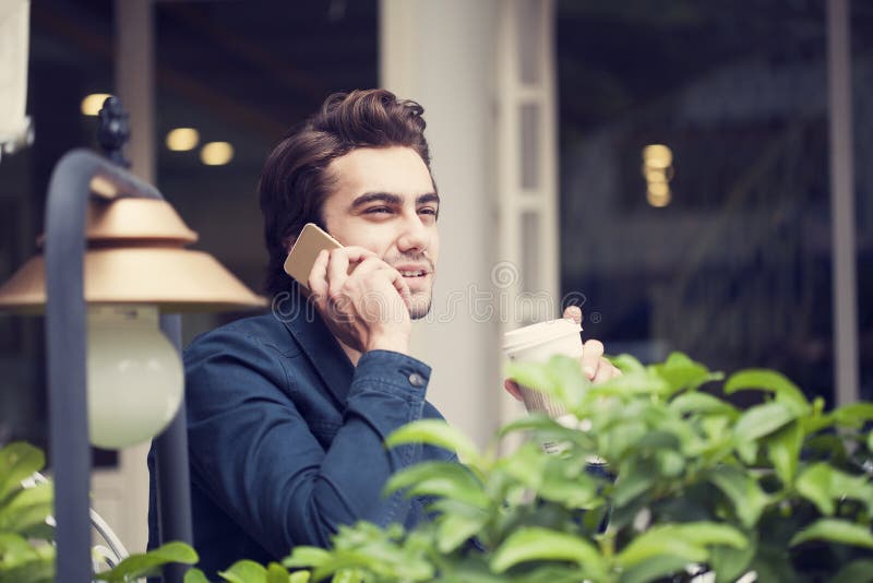 Young Man Talking Phone in Cafe Stock Image - Image of handsome ...