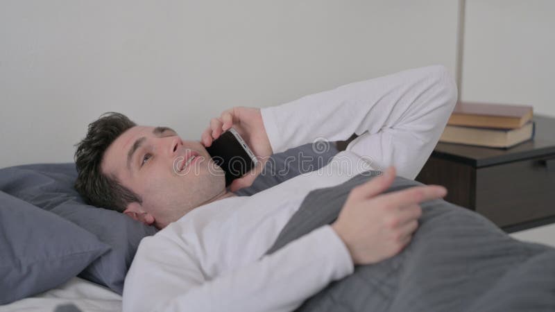 Man Talking on Phone while Sleeping in Bed Stock Image - Image of ...