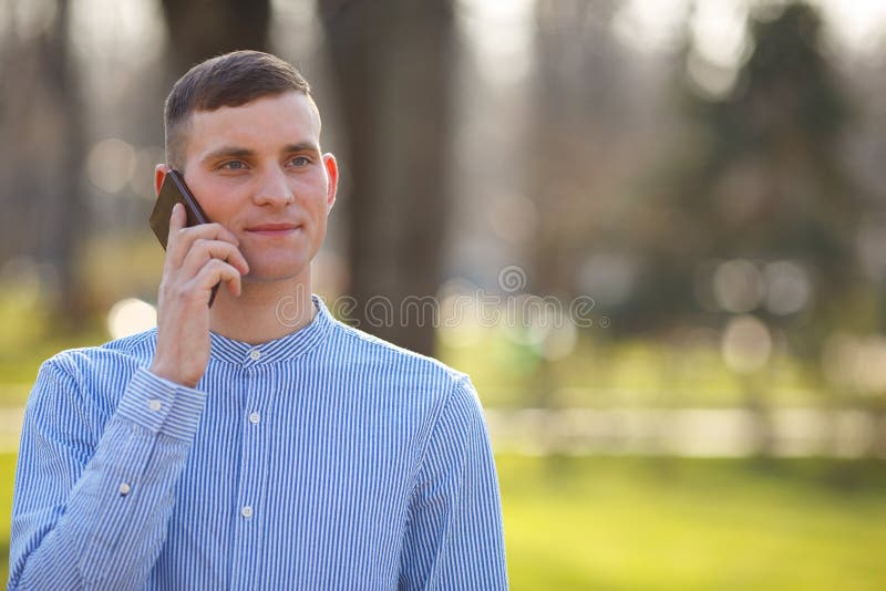 Young Man Talking on Smart Phone Outdoors. Conversation, People, Stock ...