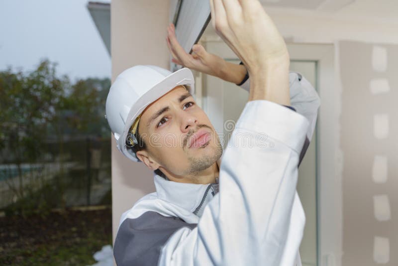 Young Man Taping Up Windows in for Hurricane Stock Photo - Image of ...